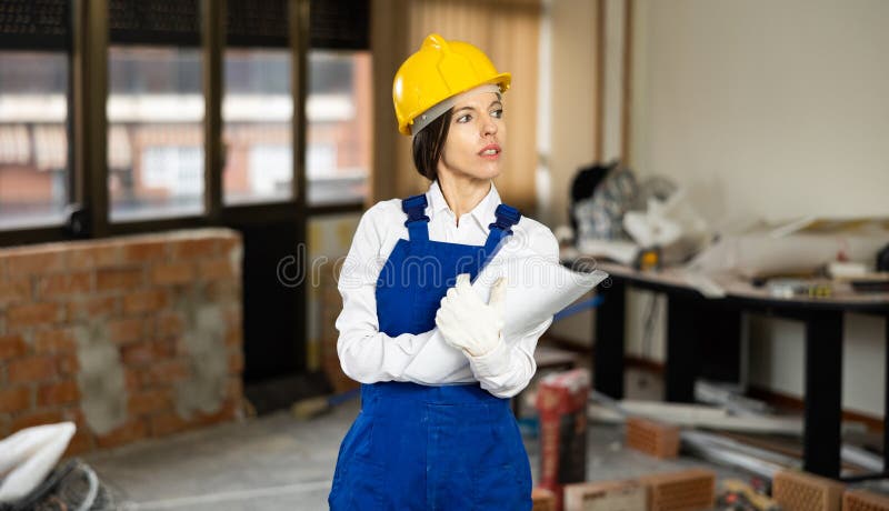 Positive Female Civil Engineer Taking Notes while Checking Indoor ...