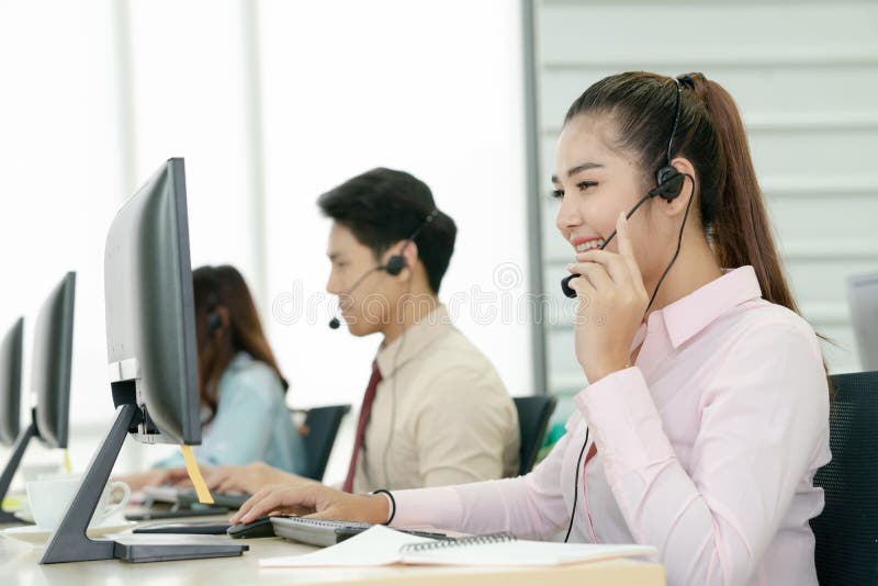 Positive Female Customer Services Agent with Headset Working in Call ...