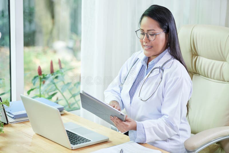 General Practitioner Working on Tablet Stock Photo - Image of clinic ...