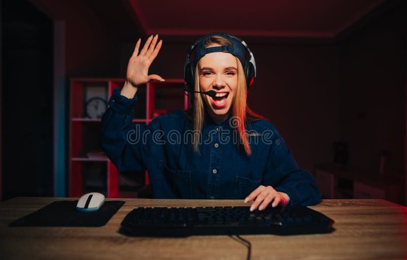 Positive Female Streamer Sits at Night in the Room at the Computer and ...