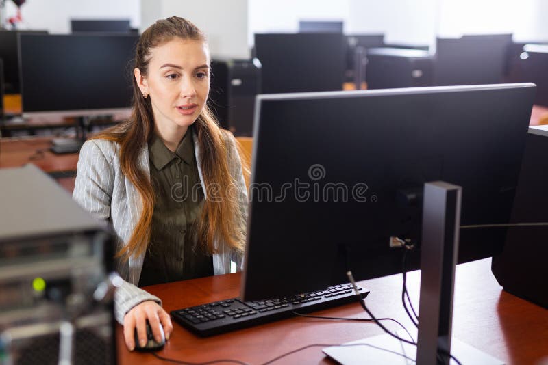 Female Teacher Working on Computer in Library University Stock Photo ...