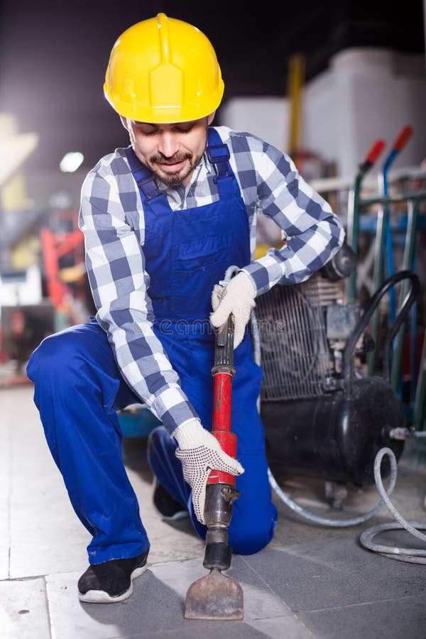 Working Man Practicing His Skills with Pneumatic Drill at Workshop ...