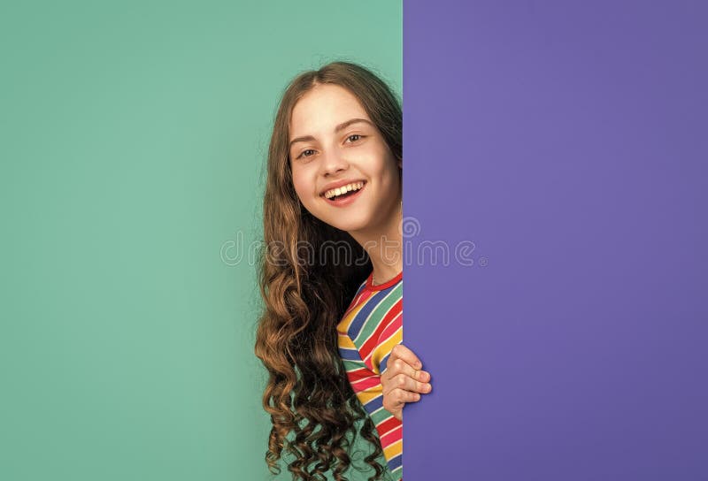 Positive Girl Behind Blank Blue Paper with Copy Space for Advertisement ...