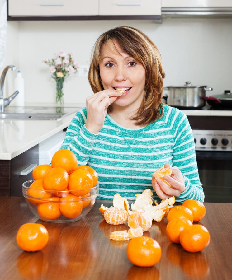 Positive Girl Eating Mandarin in Home Stock Photo - Image of ripe, 2530 ...