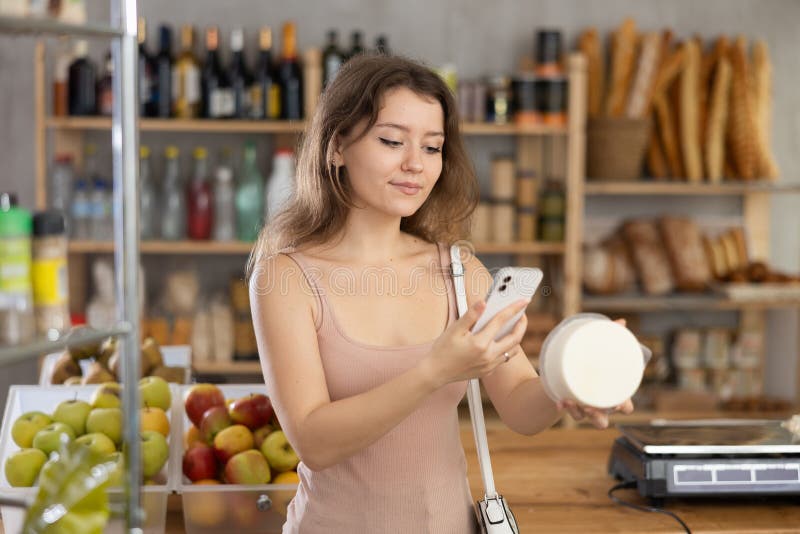 Positive Girl Purchaser Scanning QR Code or Barcode of Cheese in ...