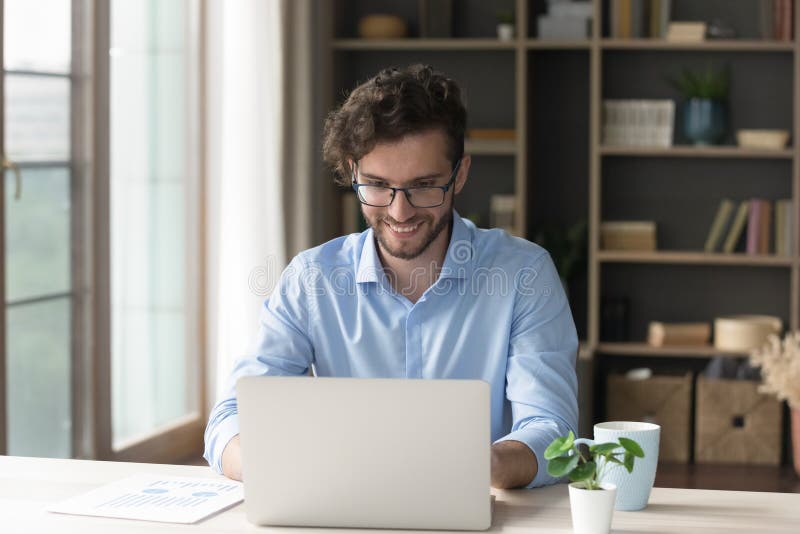 Positive Handsome Freelancer Businessman In Glasses Working At Home