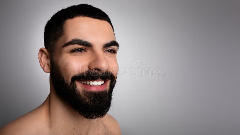 Positive Handsome Smiling Middle Eastern Man Posing on Grey Stock Photo ...