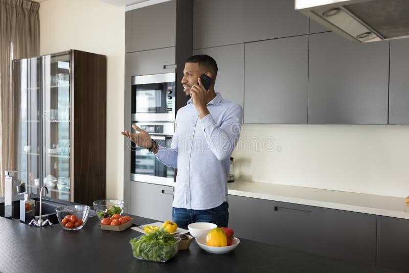 Positive Young African Chef Guy Making Call on Mobile Phone Stock Photo ...