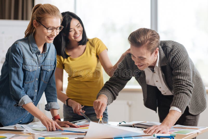 Positive Happy Designers Standing Around the Table Stock Image - Image ...