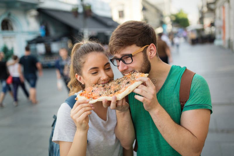 Happy Students Eating Pizza on Street Stock Photo - Image of friends ...