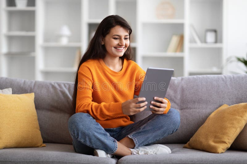 Positive Hindu Woman Holding Modern Digital Tablet In Her Hands Stock