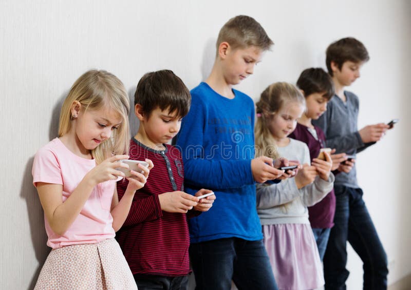 Kids Using Their Mobile Phones Stock Photo - Image of girls, learning ... Kids Using Their Mobile Phones Stock Photo - Image of girls, learning ...