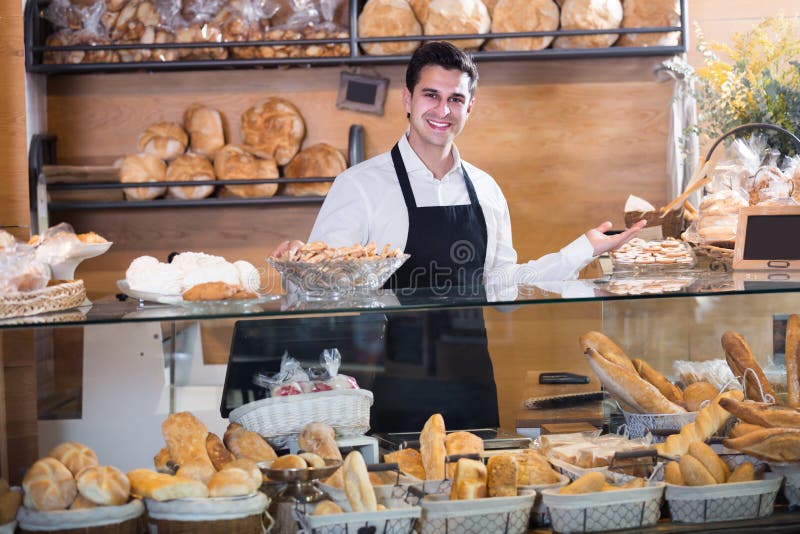 Bakery Employee Offering Bread Stock Photo - Image of industry, filled ...