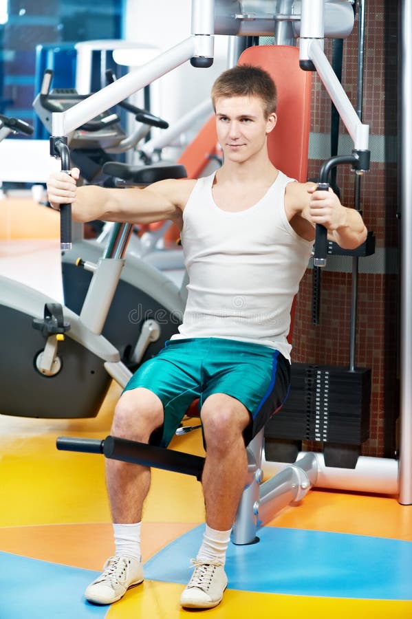 Positive Man at Chest Pectoral Exercises Machine Stock Image - Image of ...