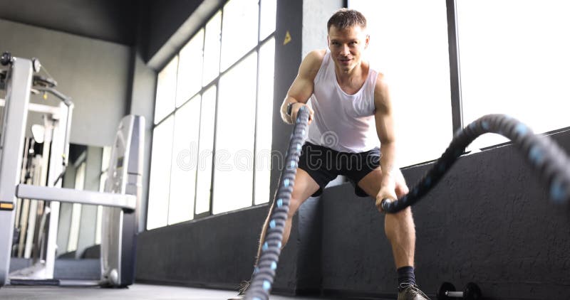 Positive Man Does Effective Exercise with Heavy Battle Ropes Stock ...