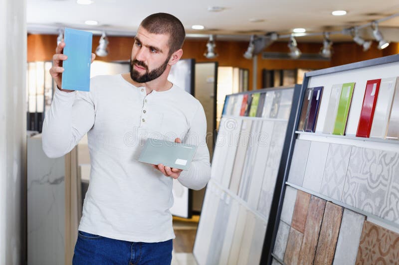 Positive Man Holding Sample of Kitchen Ceramic Tile in Modern Store ...