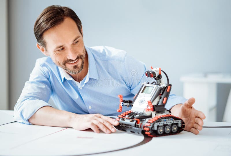 Positive man using robot stock photo. Image of future - 87444230
