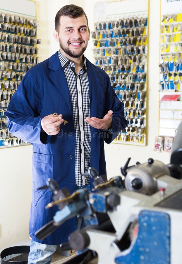 Positive Man Worker Demonstrating Repaired Key Stock Image - Image of ...
