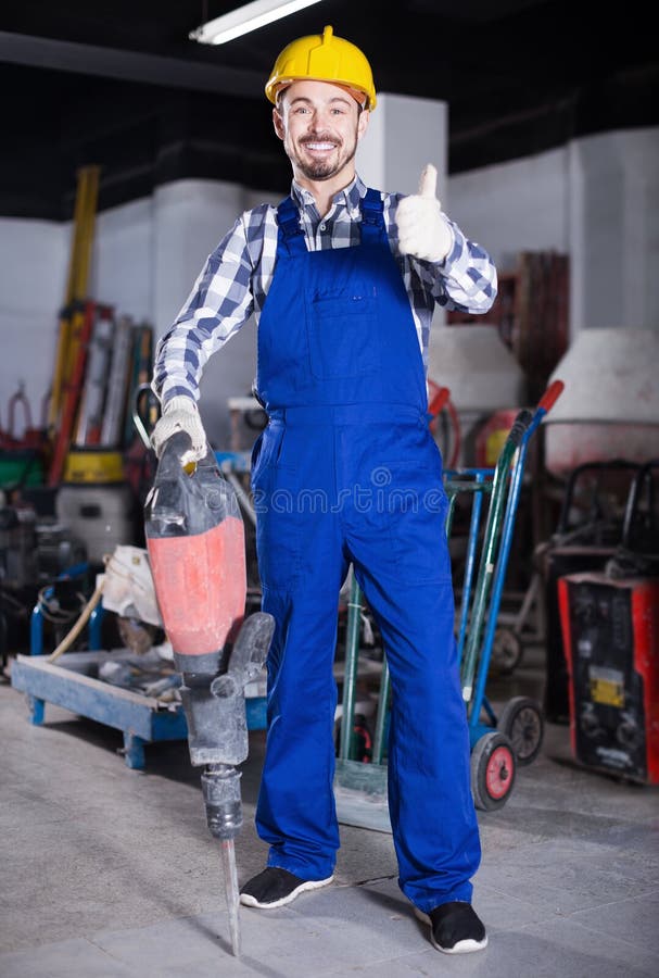 Positive Man Worker Using Jackhammer at Workshop Stock Photo - Image of ...