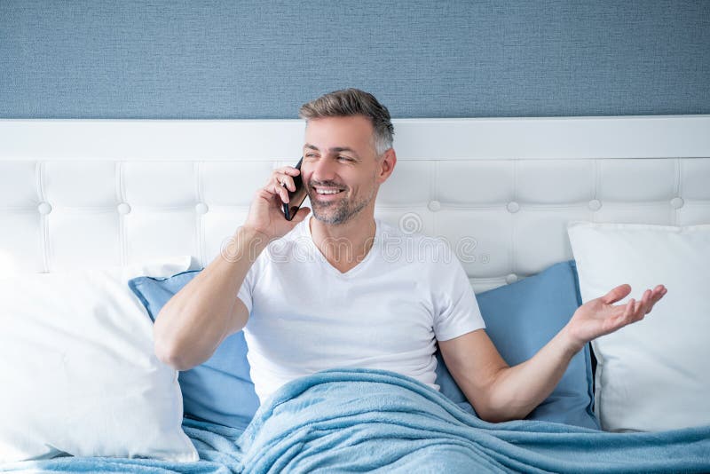 Positive Mature Man in Bed Speaking on Phone Stock Image - Image of ...