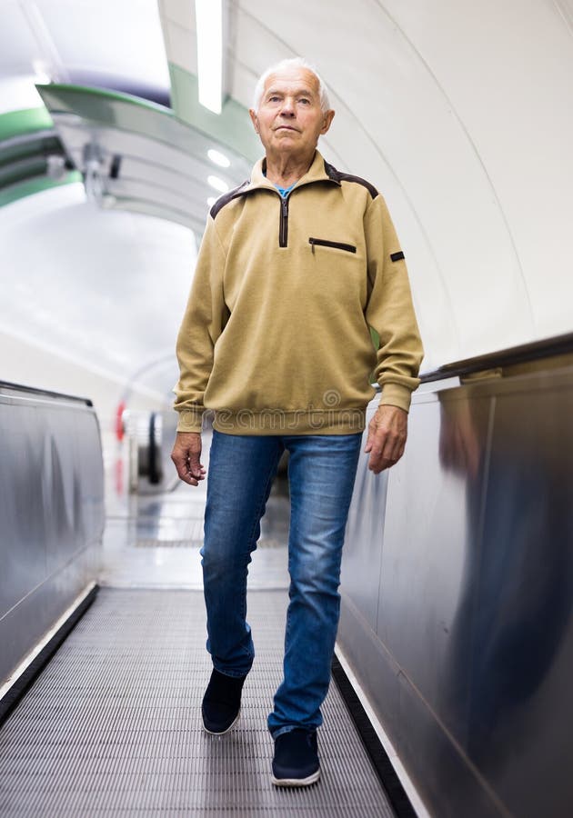 Positive Mature Man Walking Down Escalator To Subway Station Platform ...