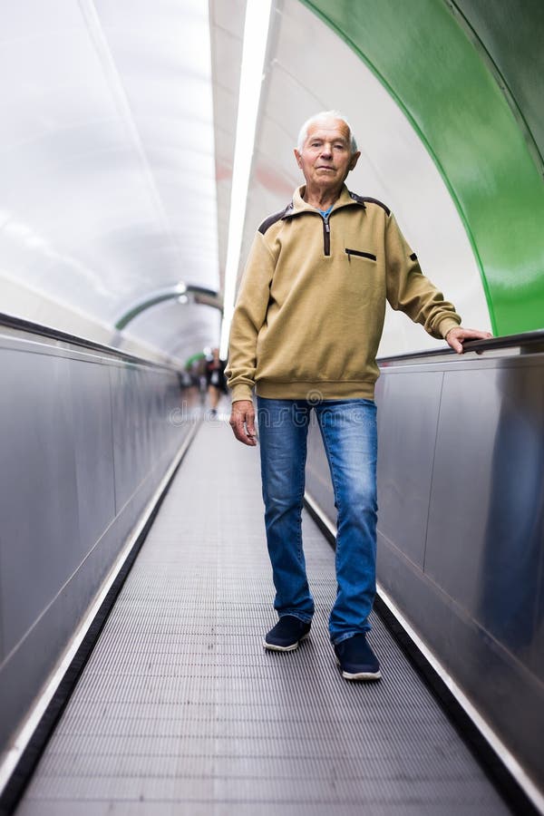 Positive Mature Man Walking Down Escalator To Subway Station Platform ...