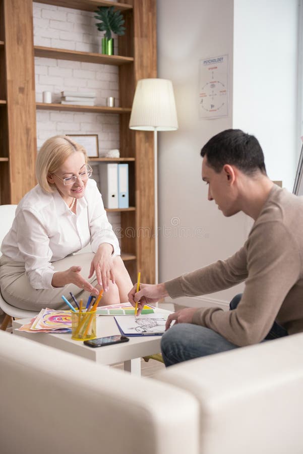 Positive Mature Psychologist Pointing at Elements Stock Image - Image ...