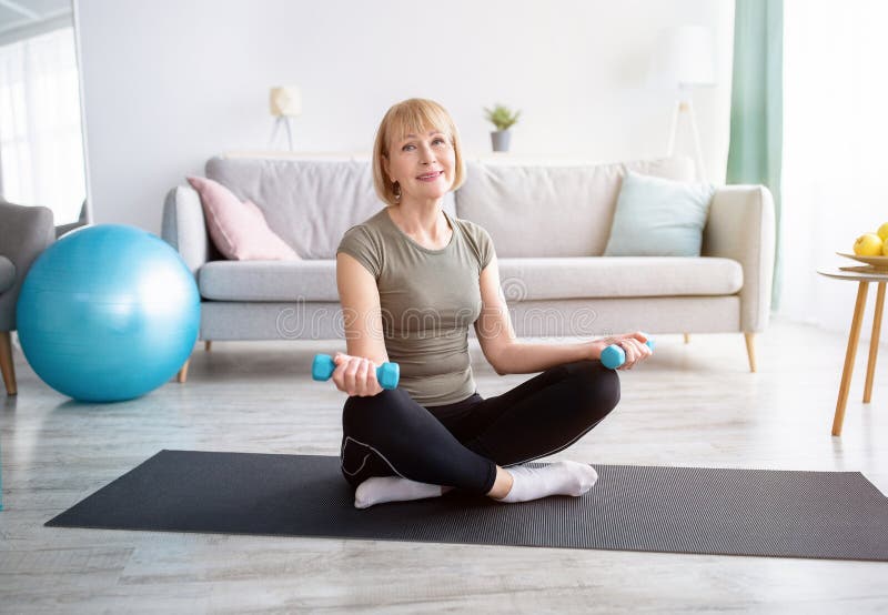 Positive Mature Woman In Sports Clothes Doing Strength Exercises With