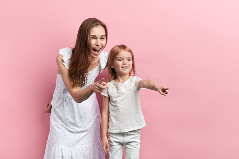 Positive Mother and Daughter Pointing Aside Stock Image - Image of ...