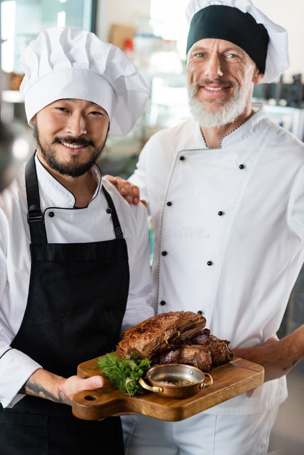 Positive Multiethnic Chefs Holding Cooked Meat Stock Image - Image of ...