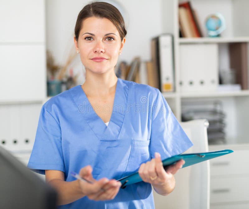 Positive Nurse with Folder of Documents at Clinic Office Stock Image ...