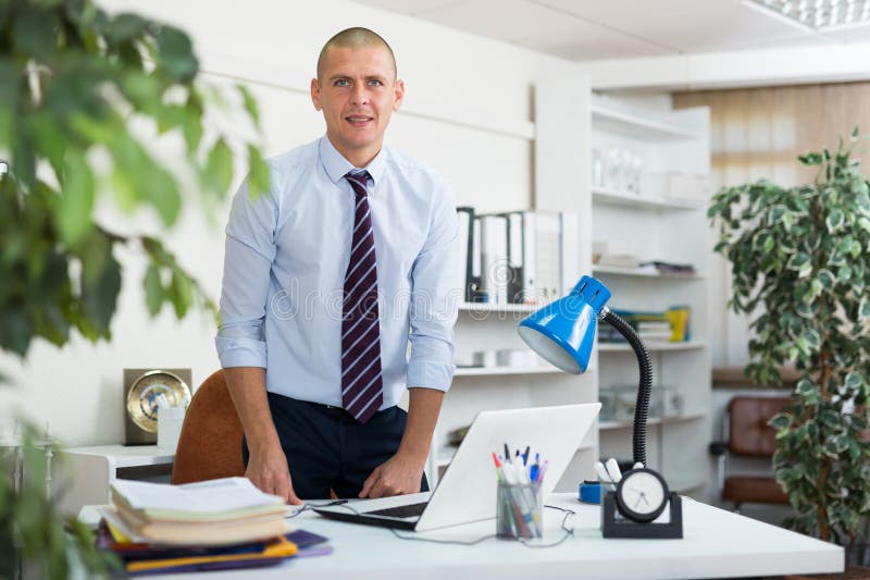 Office Worker Standing in Workplace and Looking in Camera Stock Image ...