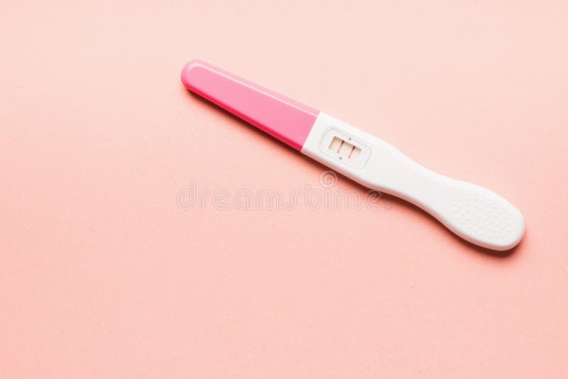 Positive Pink Plastic Pregnancy Test on Pink Background Stock Image ...