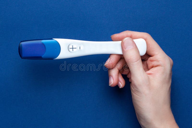 Positive Pregnancy Test in Female Hands on Blue Background Stock Image ...