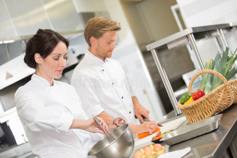 Positive Professional Chef and Cook Working at Restaurant Kitchen Stock ...