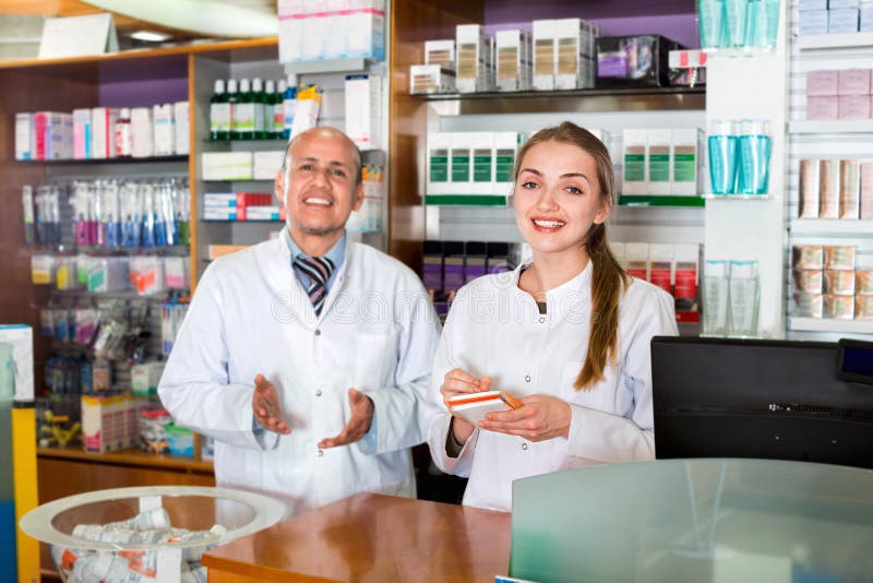 Pharmaceutists at Reception of Drugstore Ready To Help Stock Image ...
