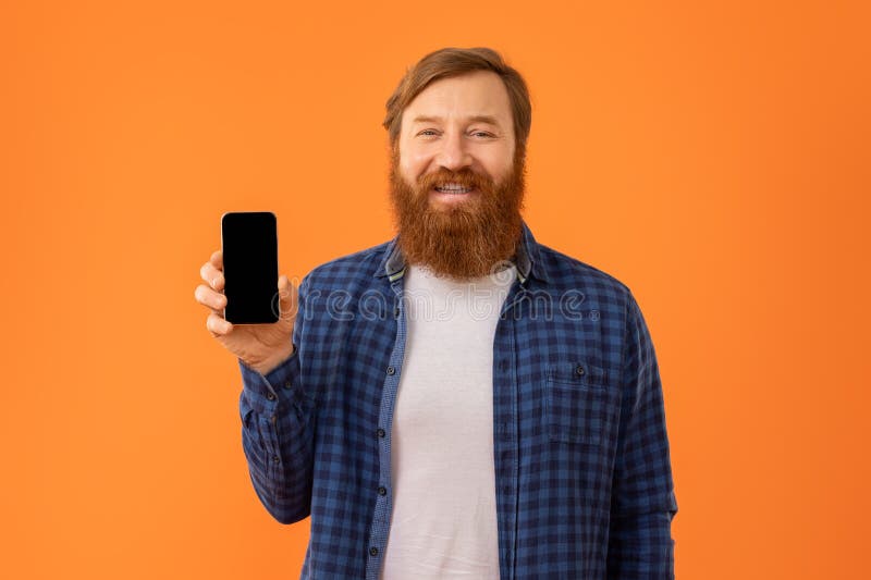Positive Redhaired Bearded Man Showing His Smartphone Blank Screen ... Positive Redhaired Bearded Man Showing His Smartphone Blank Screen ...