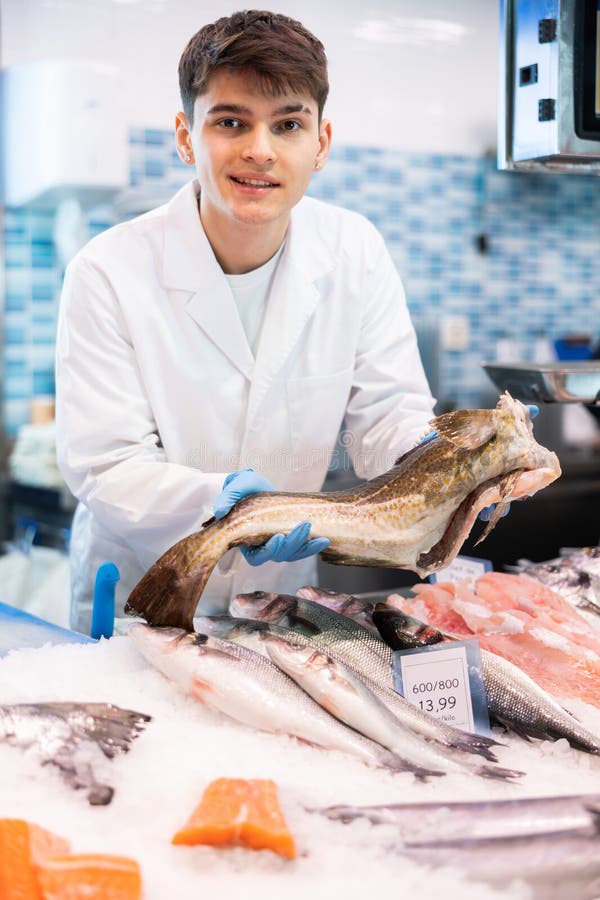 Positive Salesman Demonstrating Cod in Fish Store Stock Image - Image ...