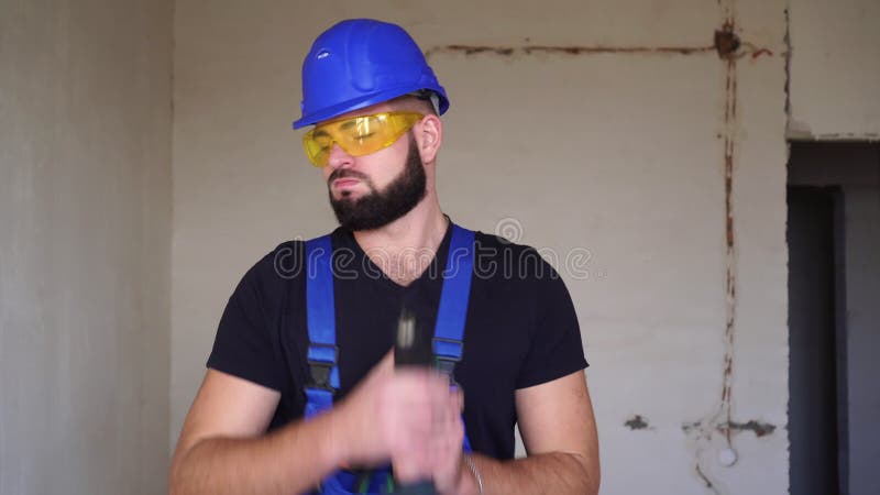 Positive Male Builder Dancing with an Electric Screwdriver. Stock ...