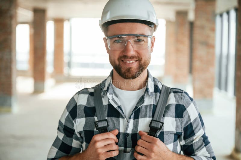 Positive Smiling Construction Worker in Uniform in Empty Unfinished ...