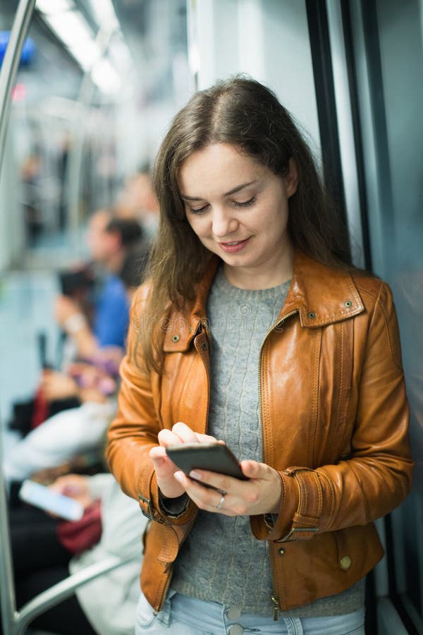 Positive Smiling Girl Reading from Mobile Phone Screen Stock Photo ...