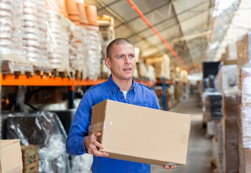 Positive Warehouse Worker Dragging Boxes on Hands Stock Photo - Image ...