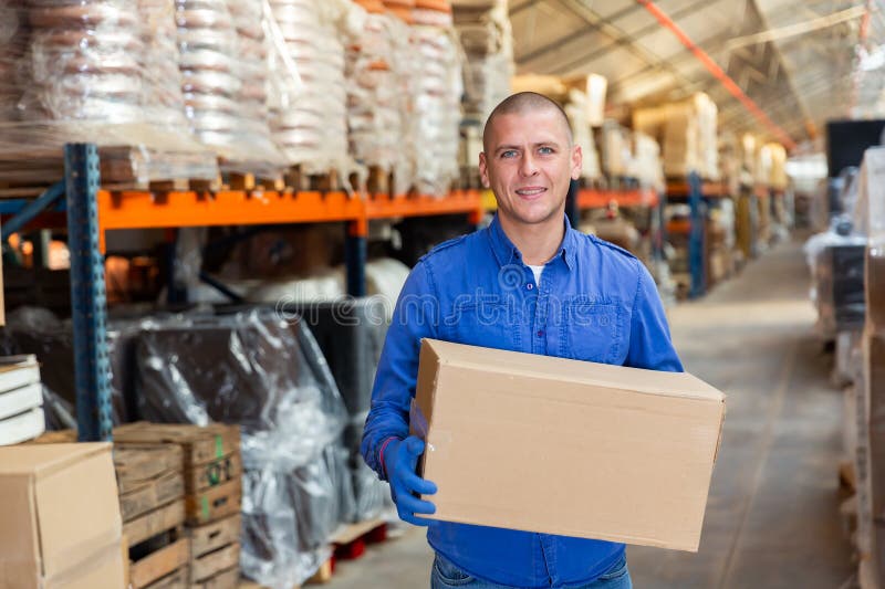 Positive Warehouse Worker Dragging Boxes on Hands Stock Image - Image ...