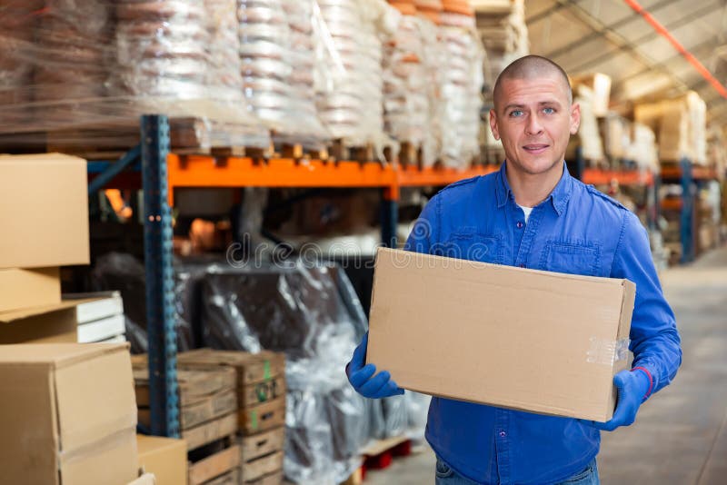 Positive Warehouse Worker Dragging Boxes on Hands Stock Photo - Image ...