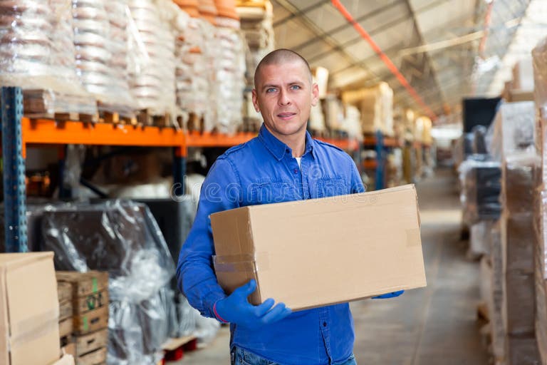 Positive Warehouse Worker Dragging Boxes on Hands Stock Photo - Image ...