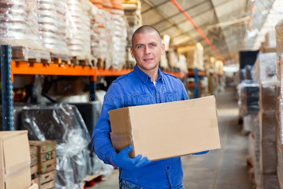 Positive Warehouse Worker Dragging Boxes on Hands Stock Photo - Image ...