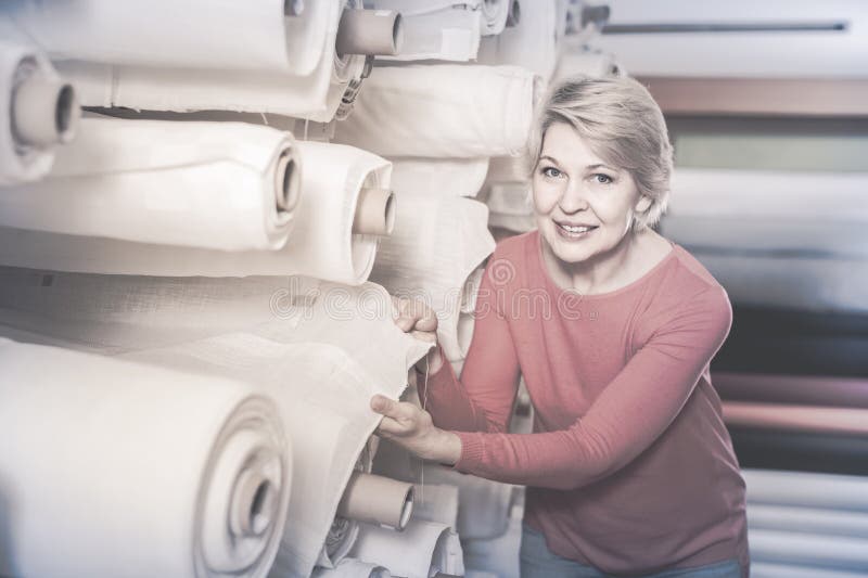 Positive Woman Choosing Interesting Fabric Stock Photo - Image of ...