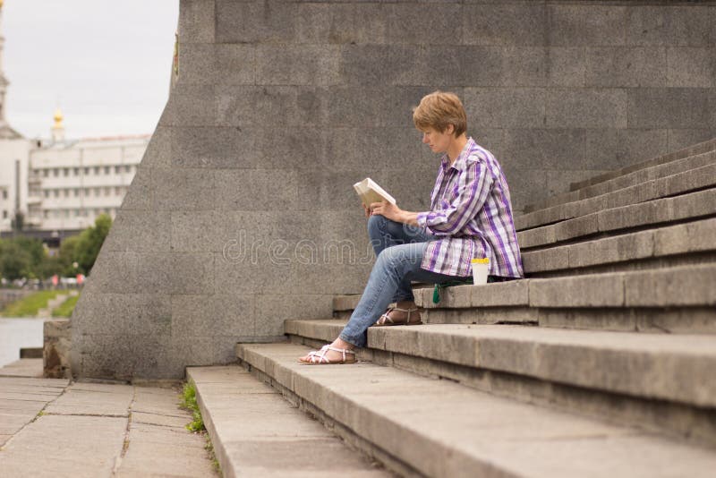 Positive Woman Sitting and Reading a Book Stock Image - Image of ...