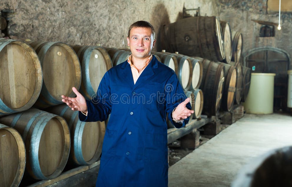 Positive Worker Posing with Wine Barrels Stock Photo - Image of owner ...