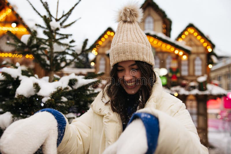 Positive Young Caucasian Girl Smiling Looking At Floor Stands Outdoor